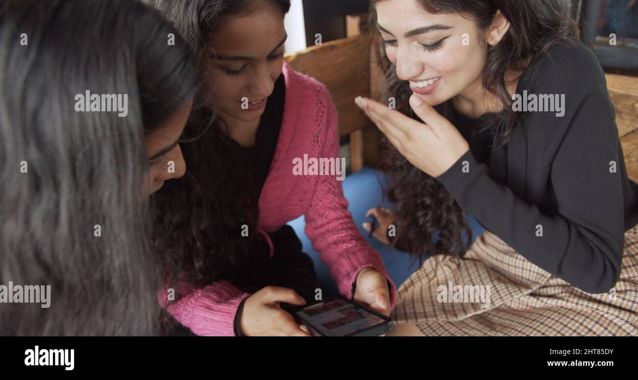 Indian female showing her friends something from her smartphone Stock ... Indian female showing her friends something from her smartphone Stock ...