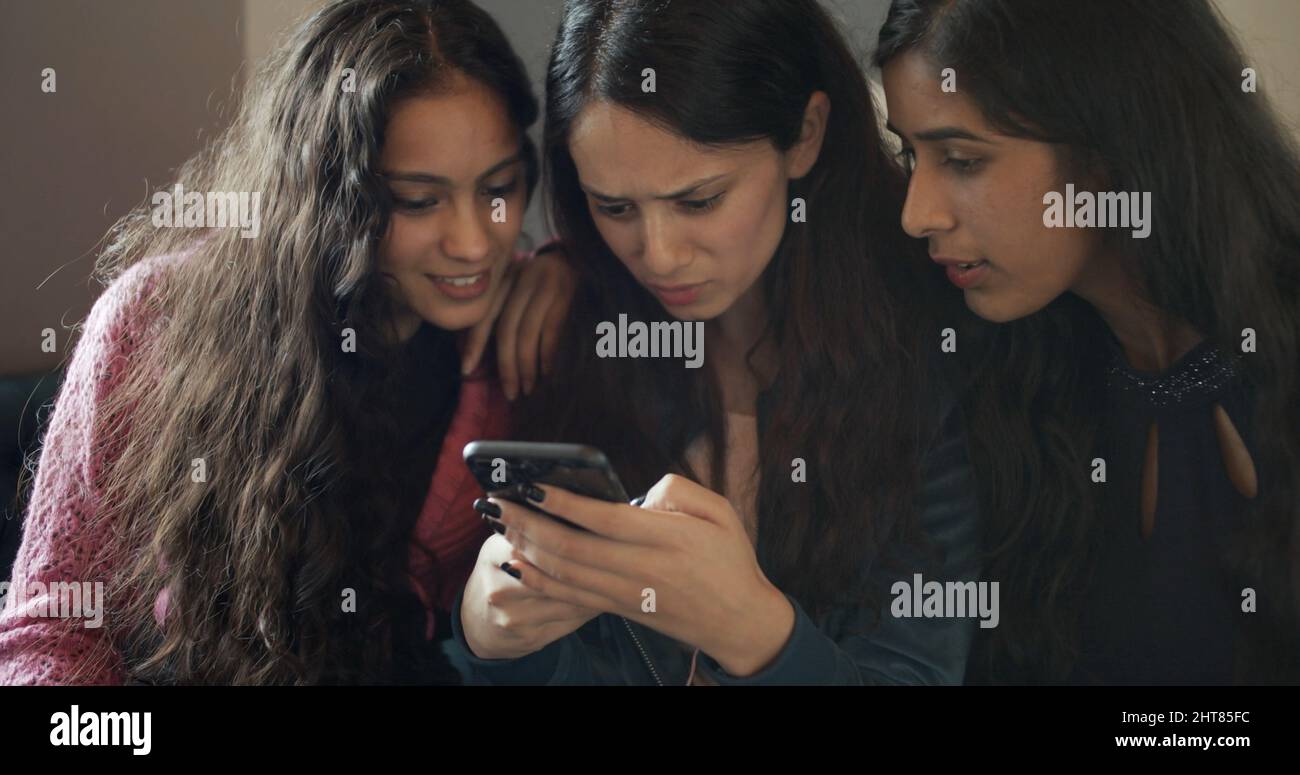 Indian female showing her friends something from her smartphone Stock ... Indian female showing her friends something from her smartphone Stock ...