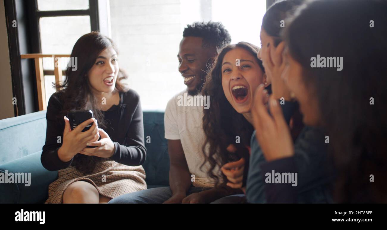 Group of young happy smiling friends gathered and having a good time ...