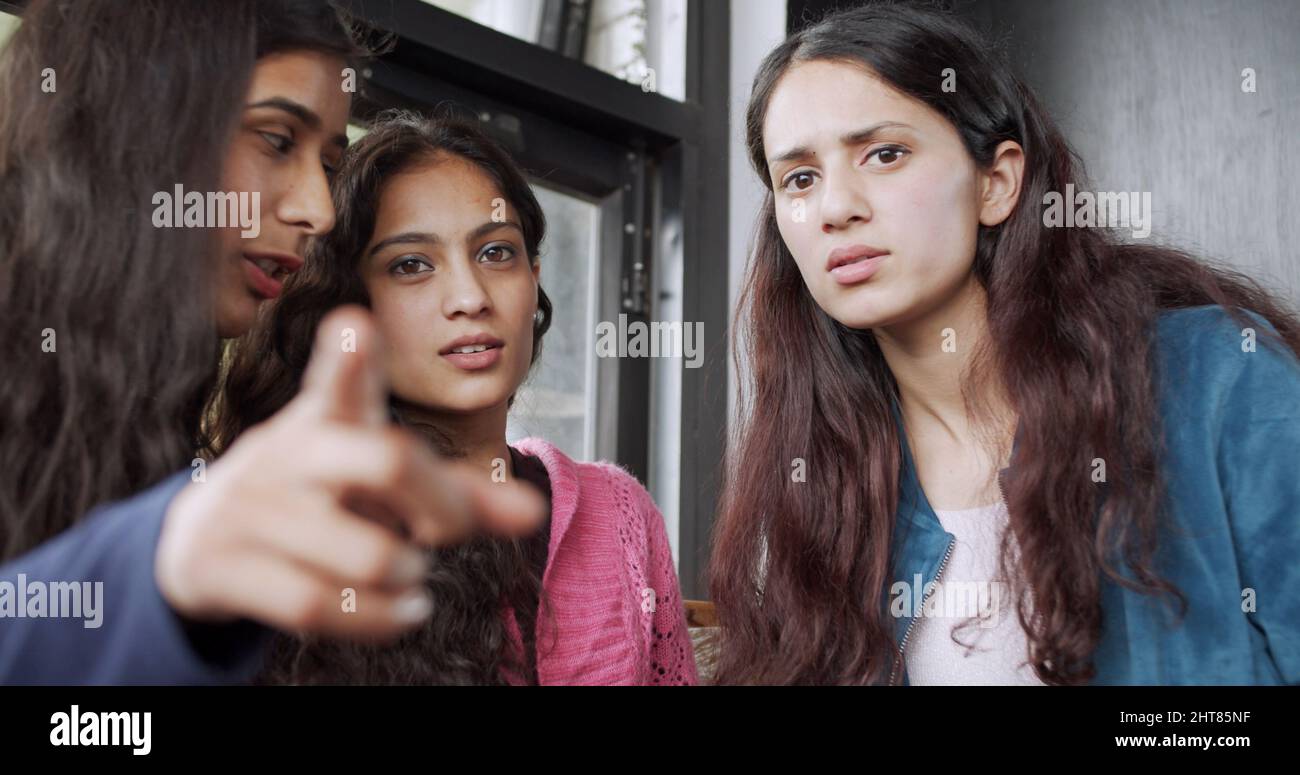 Group of Indian young female looking at the camera with serious faces ...