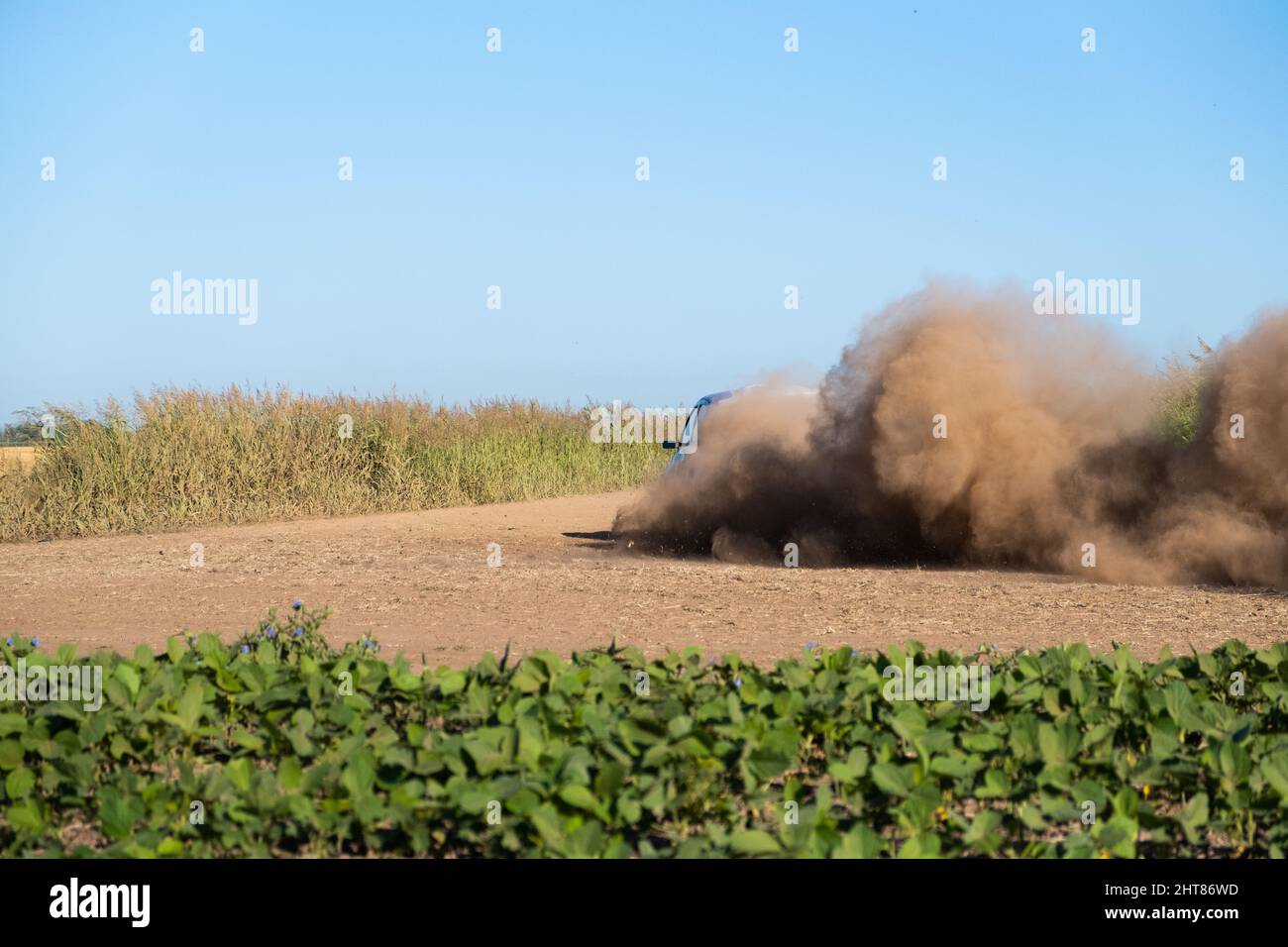 Car raising dust on a rural field Stock Photo - Alamy