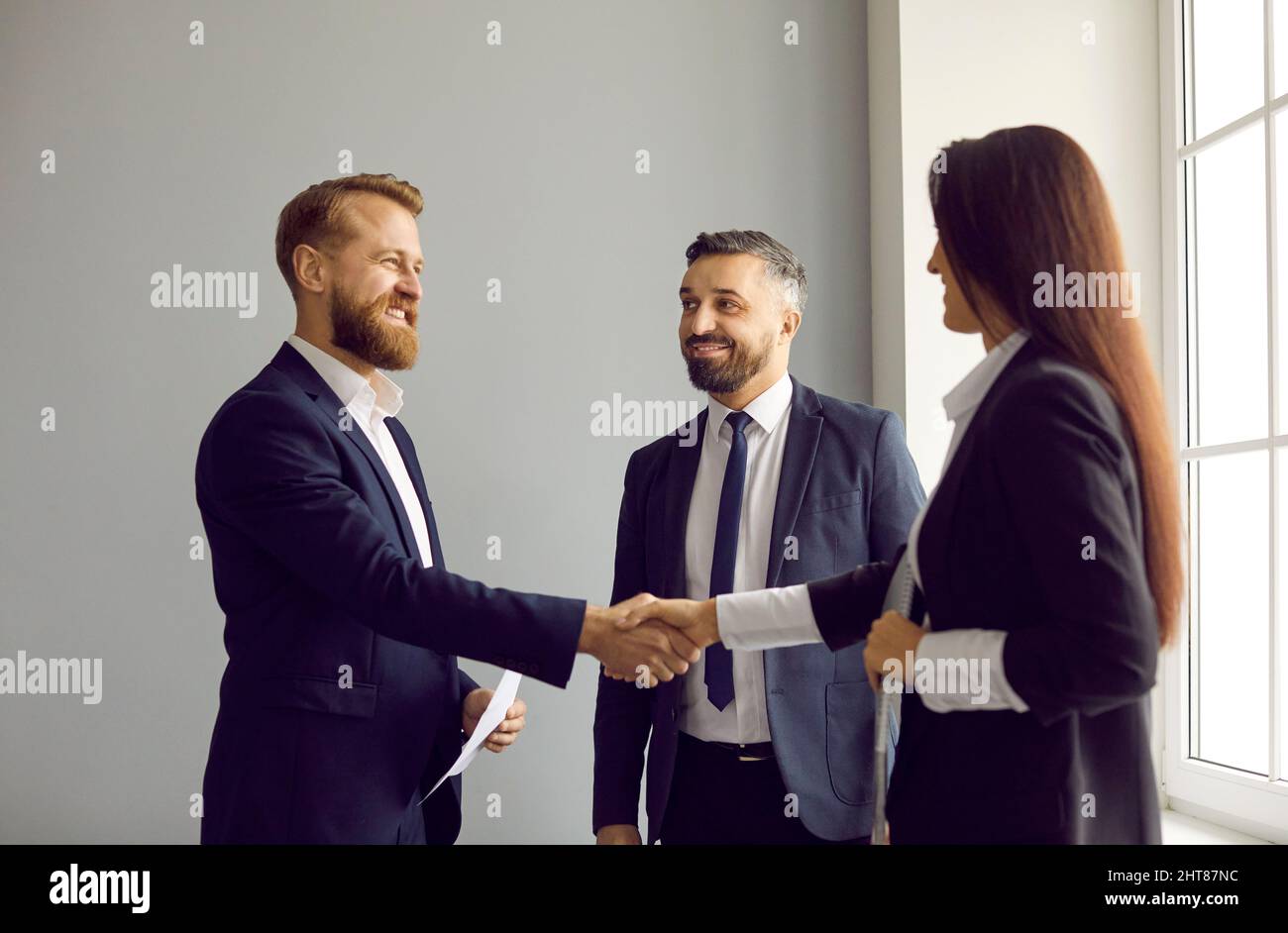 Two happy business professionals making partnership deal and exchanging handshakes Stock Photo ...
