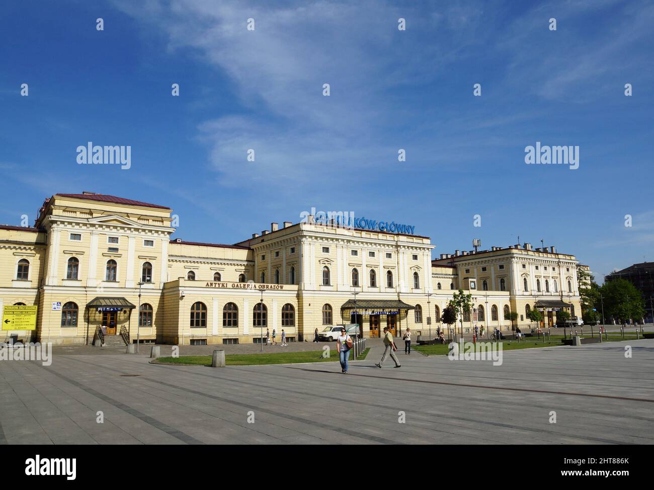 Closeup of People walking on a square in front of the main train ...
