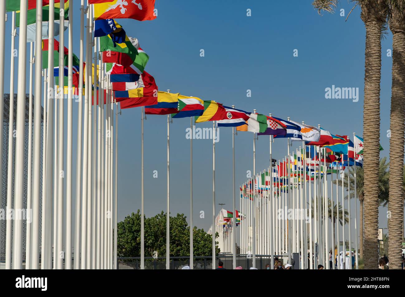 Many world flags flying in a row outside of expo center in 2020 waving ...