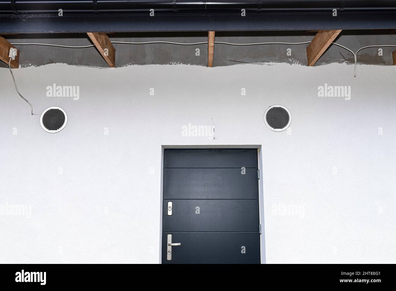Air intake and exhaust in the wall of a single family house for ...
