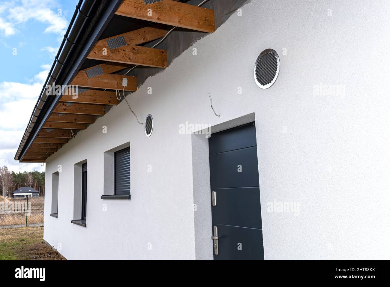 Air intake and exhaust in the wall of a single family house for ...