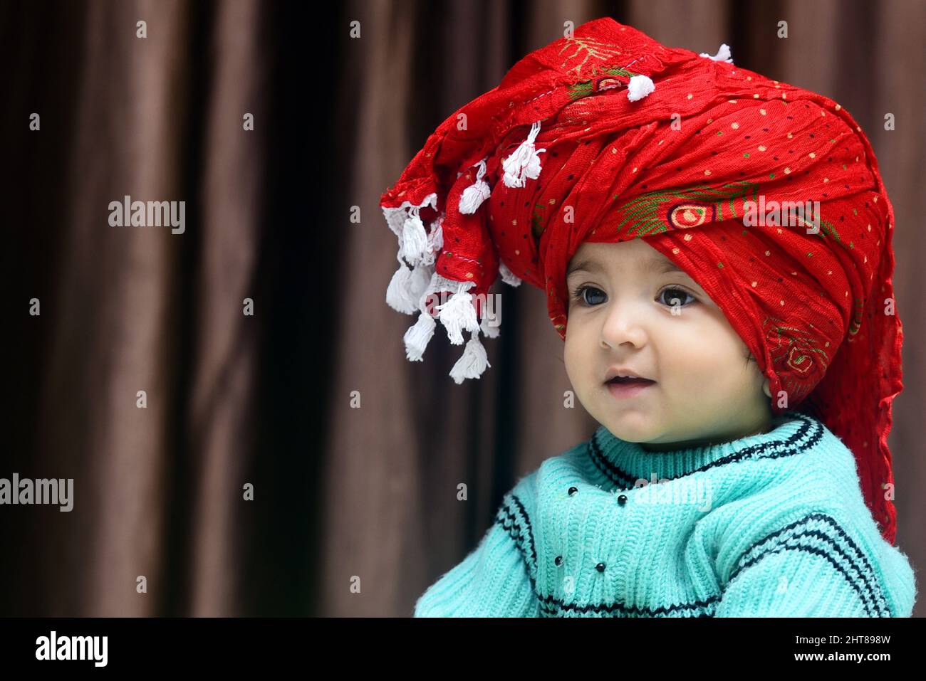 Portrait of an adorable Indian child wearing a red turban Stock Photo ...