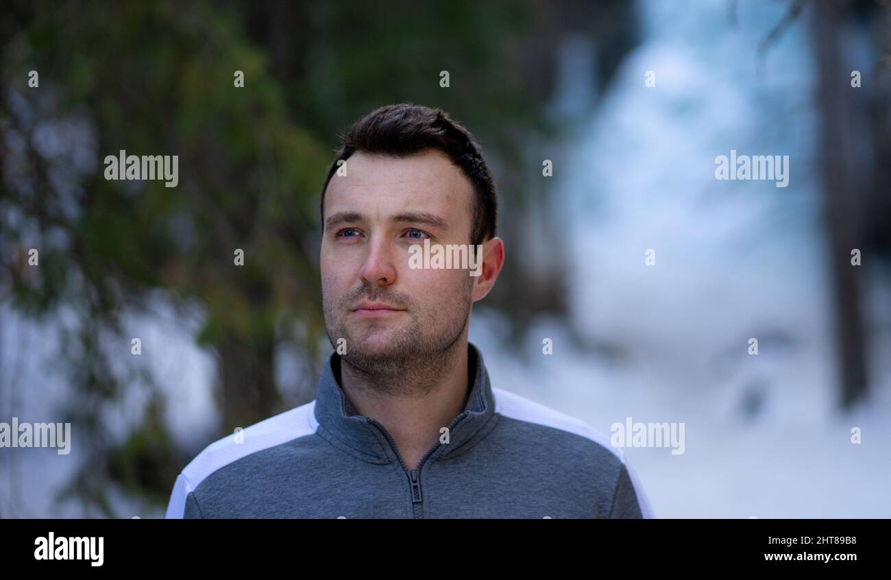 Cold walk by a frozen waterfall headshot Stock Photo - Alamy