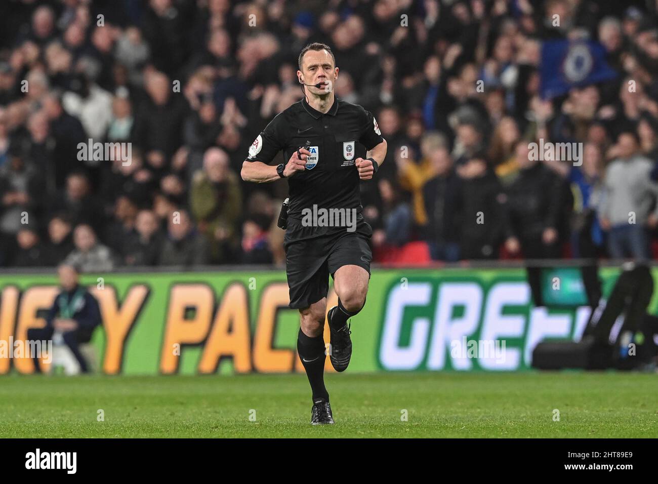 Referee Stuart Attwell makes his way back after checking the VAR screen ...