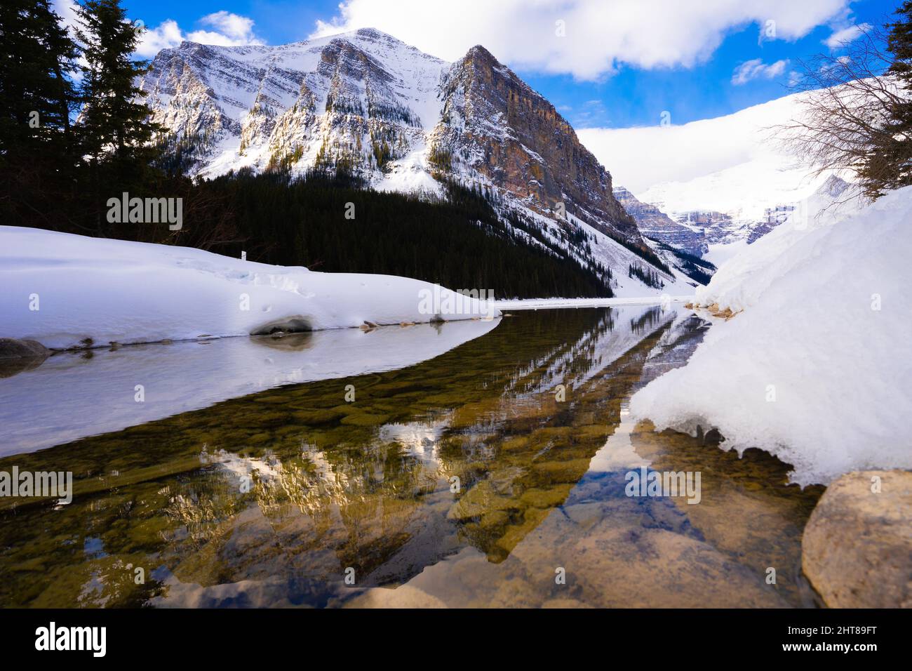 Little reflection of frozen Lake Louise Stock Photo - Alamy