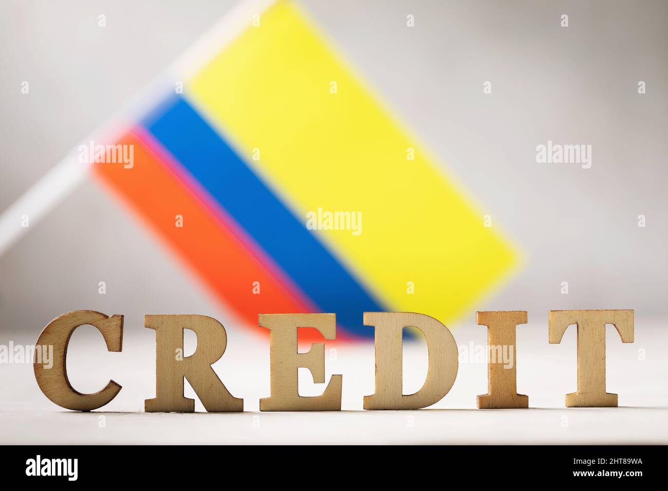 Text from wooden letters and Colombian flag on an abstract background ...