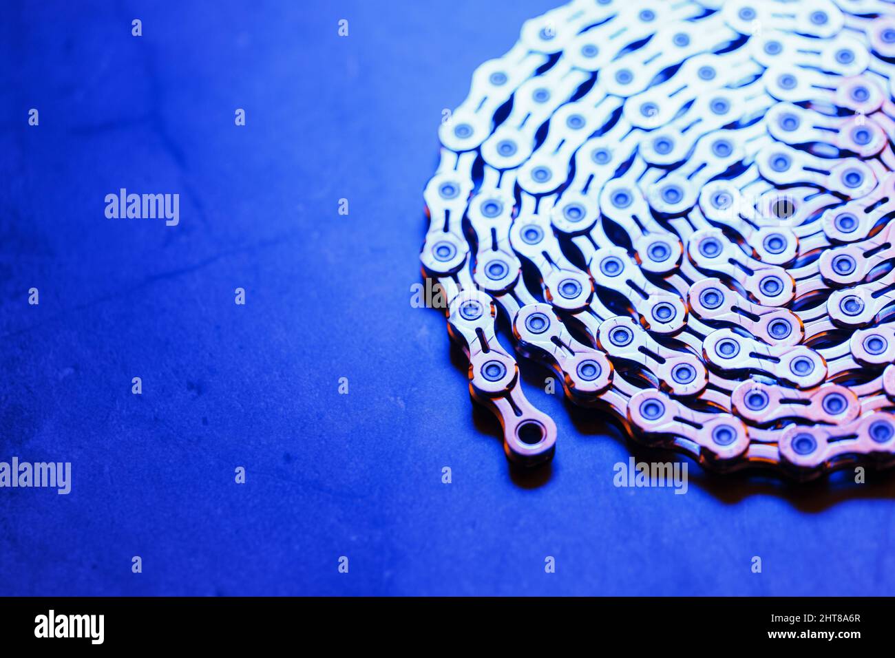 Patterns of a technological bicycle chain braided in a circle with blue ...