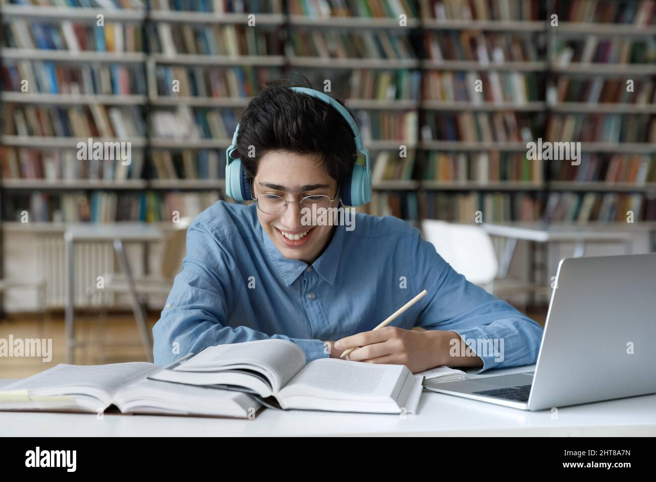 Happy millennial Jewish male student studying in library Stock Photo ...