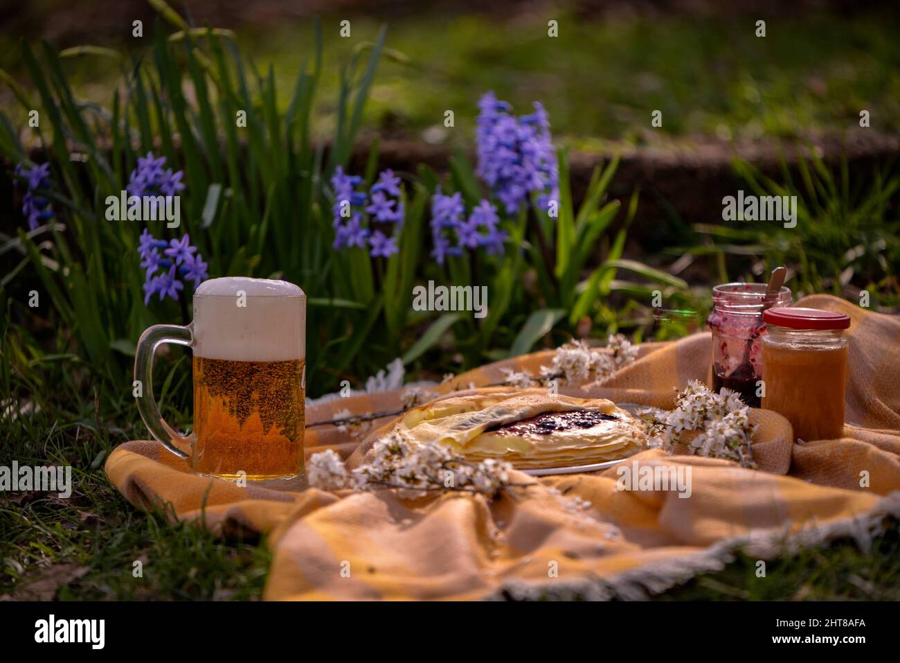 Closeup of beer cups during a picnic a plate of pancakes with jam on ...