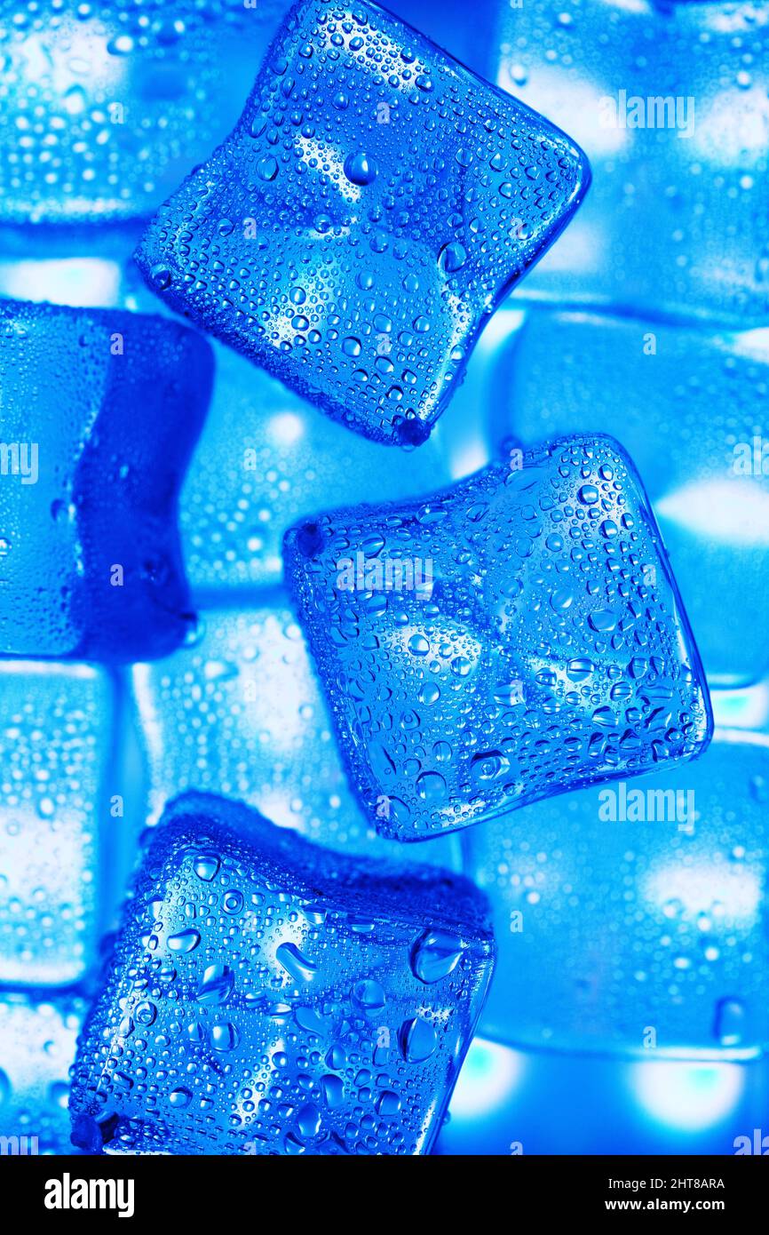 Ice cubes with blue backlight in the freezer close-up in full screen ...