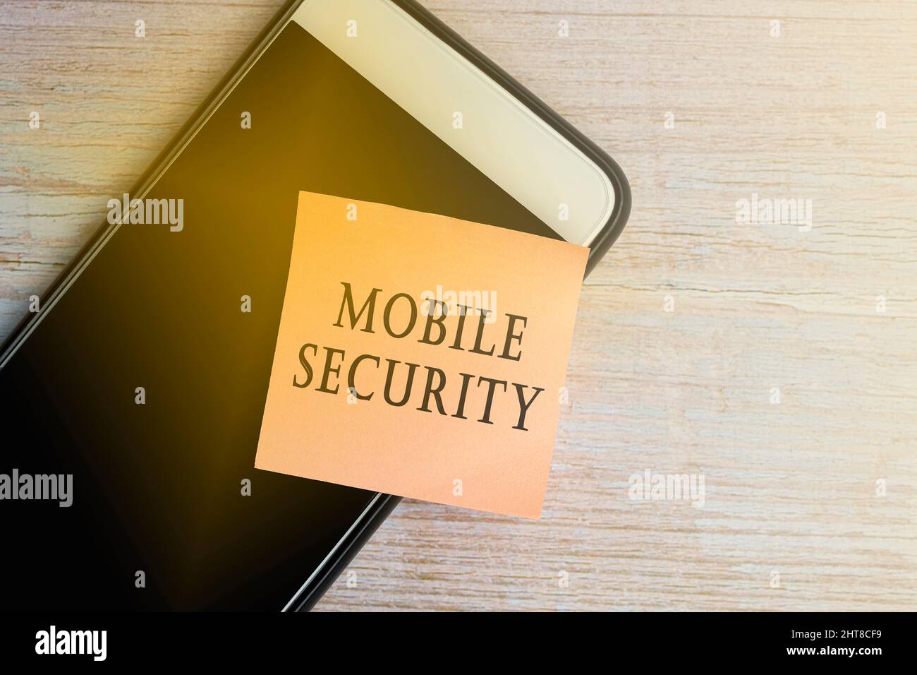 Mobile security text on notepad with smartphone on wooden desk Stock ...