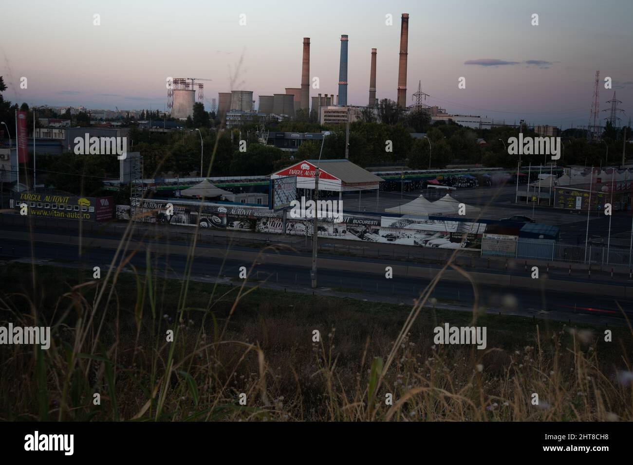 Closeup of a building and industrial chimneys Stock Photo - Alamy