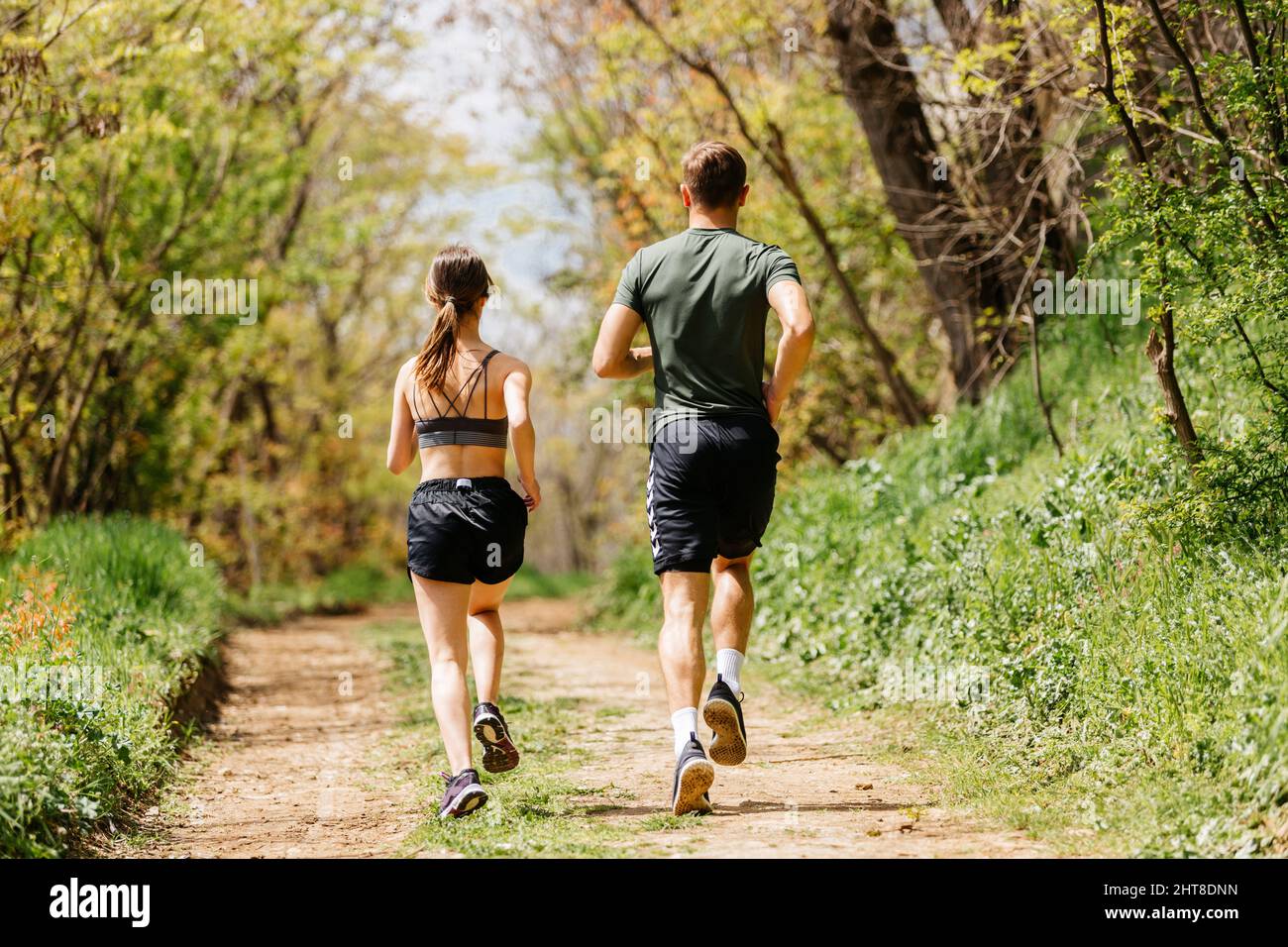 Sport people running in park together. Young couple jogging at outdoor ...