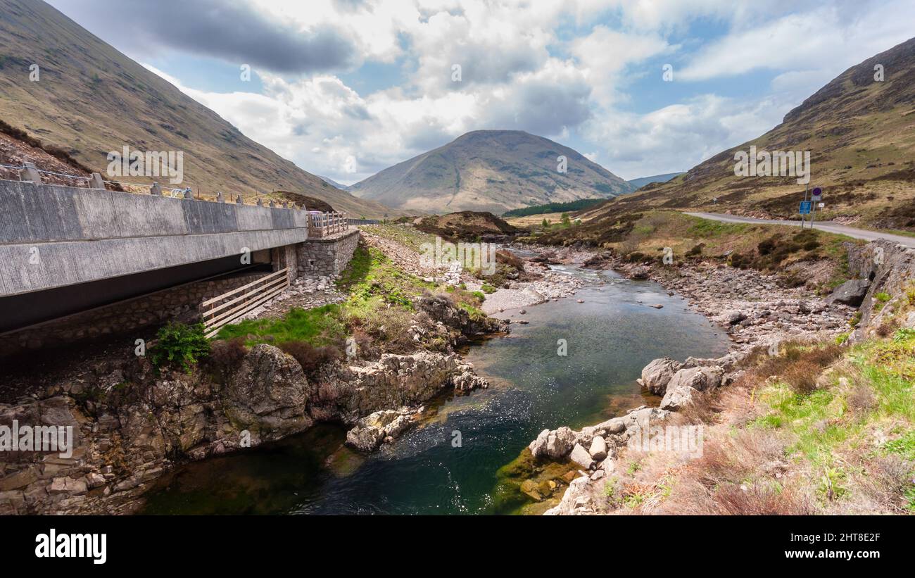 The River Coe tumbles over rocks beside the A82 road in Glen Coe valley ...