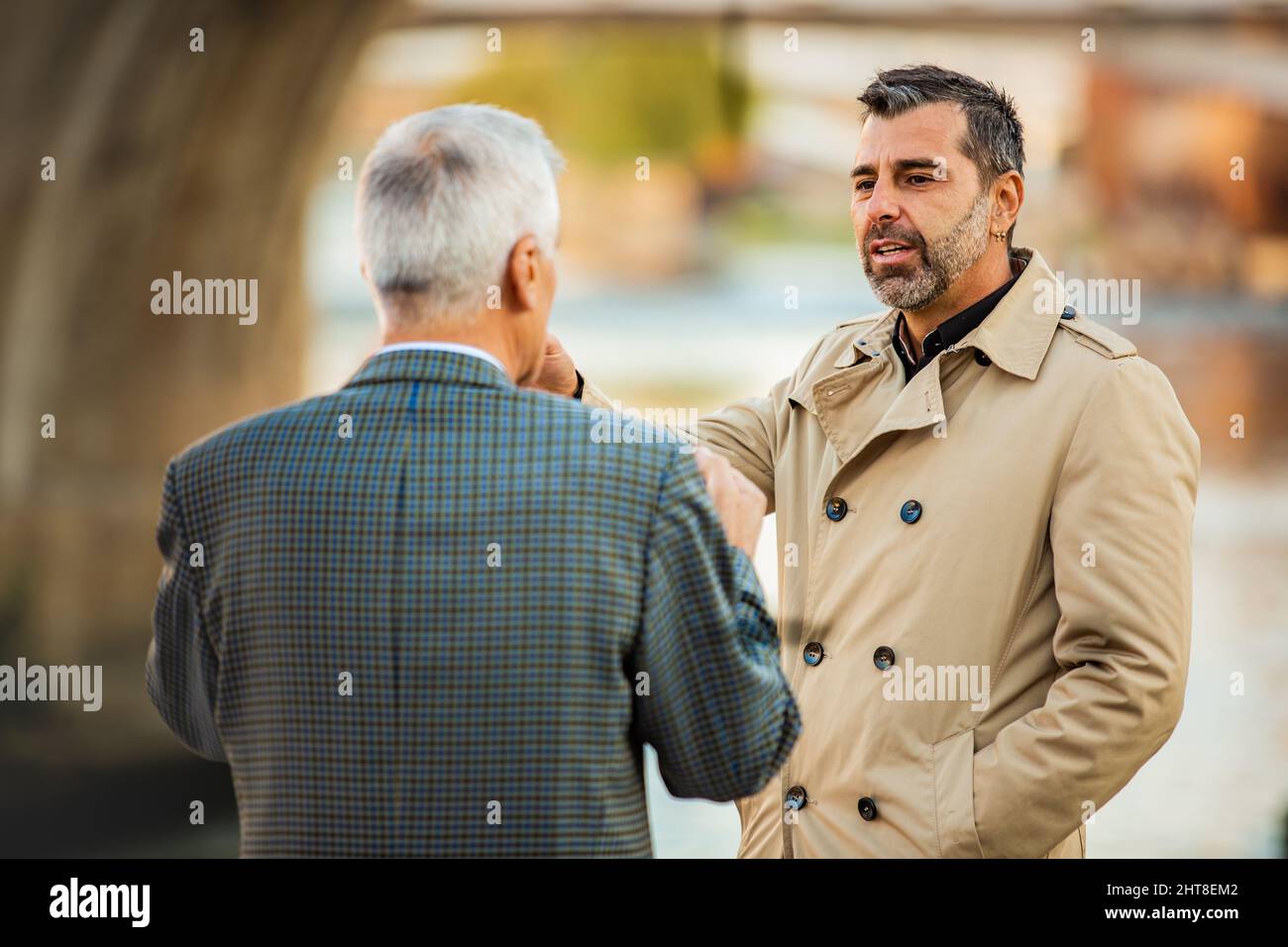 Two amazing senior businessmen are talking to each other, close up ...