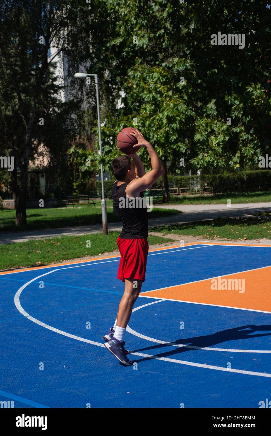 Basketball player jump shooting and playing basketball Stock Photo - Alamy