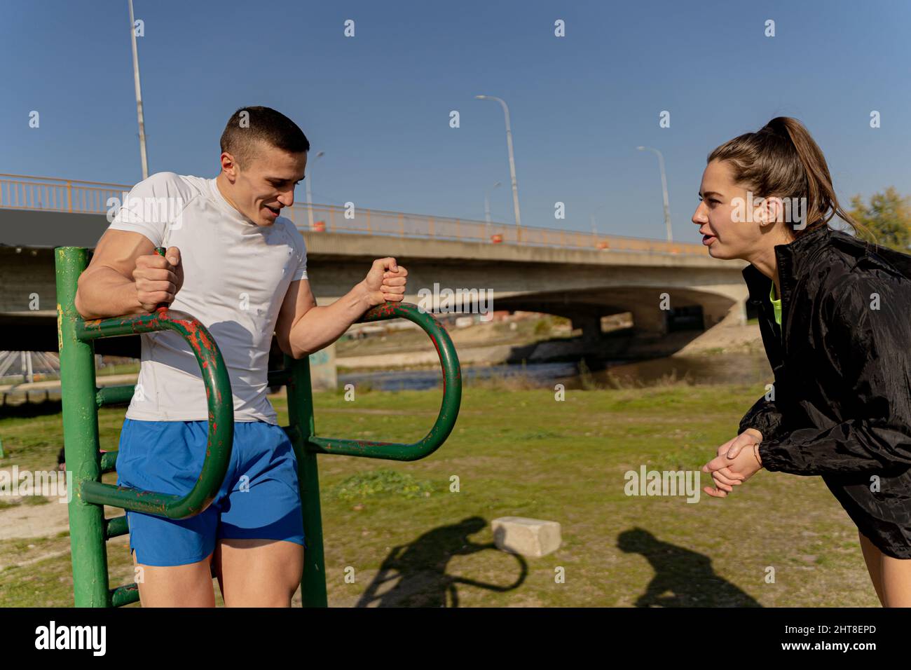 Two attractive and maazing fit friends are laughing and helping each ...