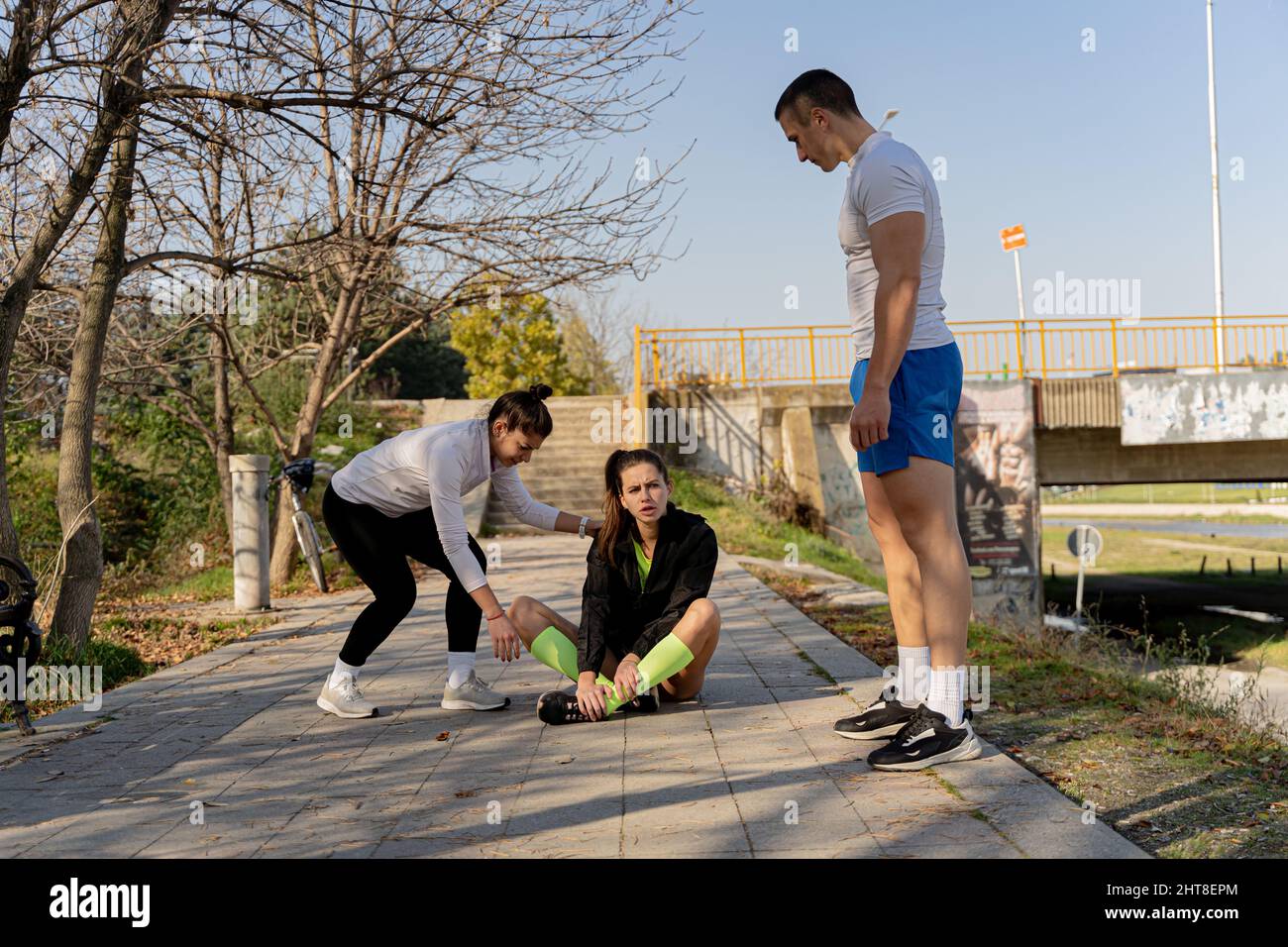 Attractive and beautiful fit girl is sitting while being injured Stock ...