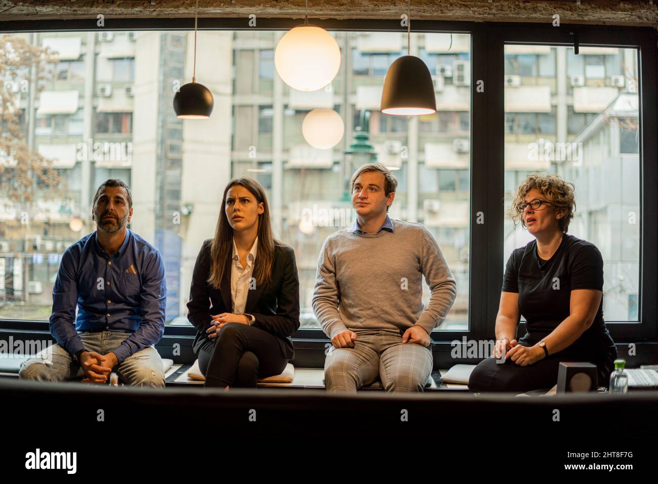 Four amazing business people are listening to the presentation Stock ...