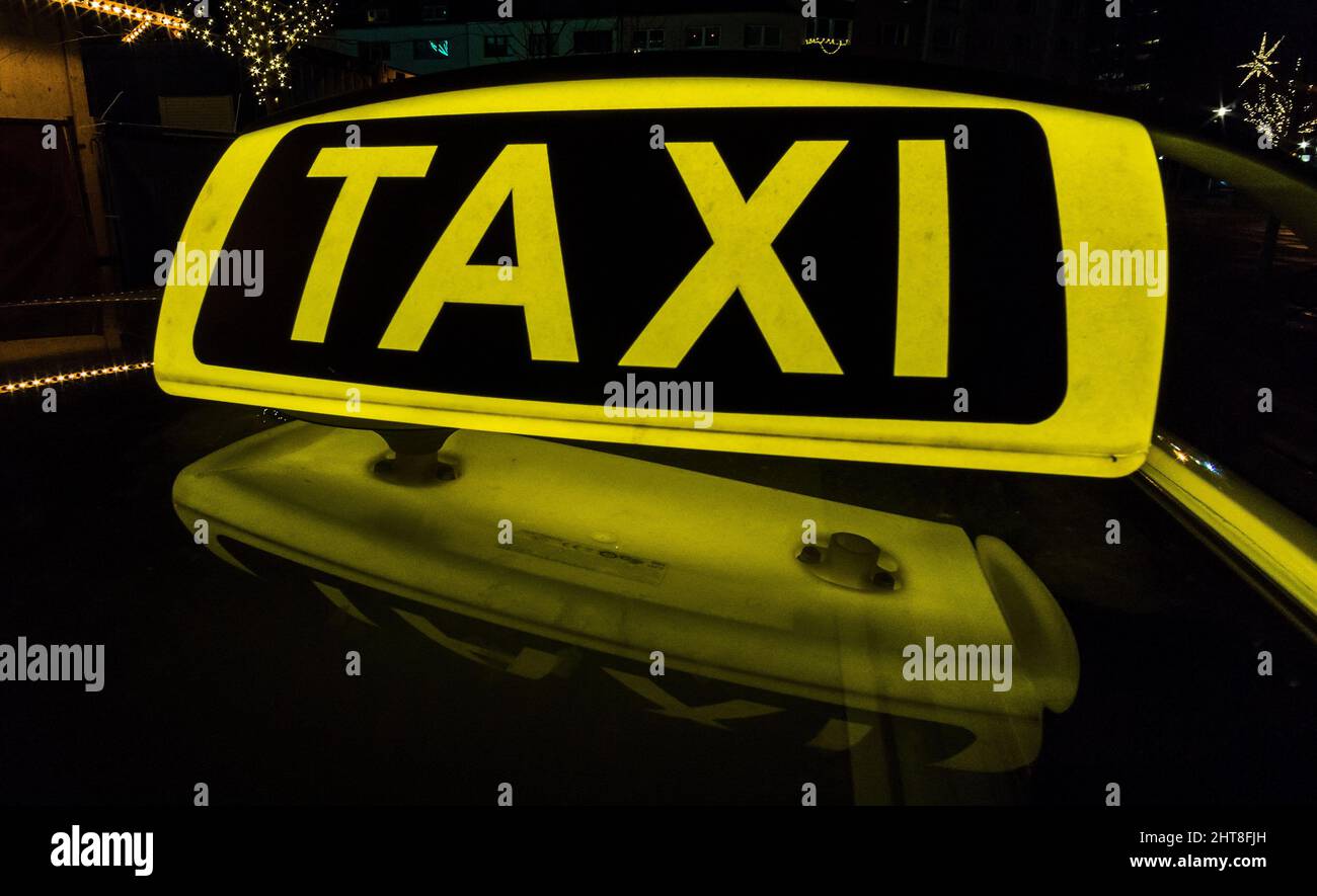 Closeup of an illuminated taxi sign Stock Photo - Alamy