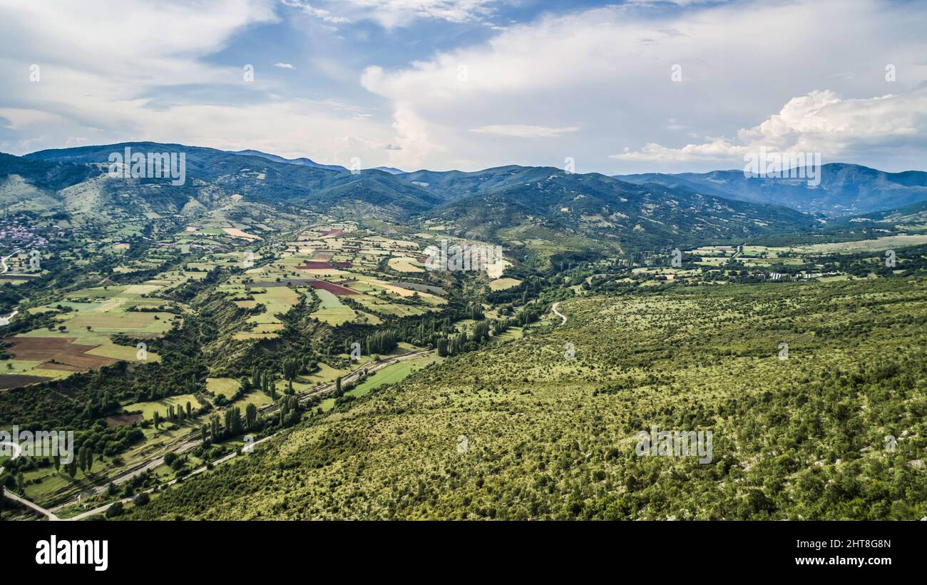 Landscape with green fields, trees and mountains in Greece with a light ...