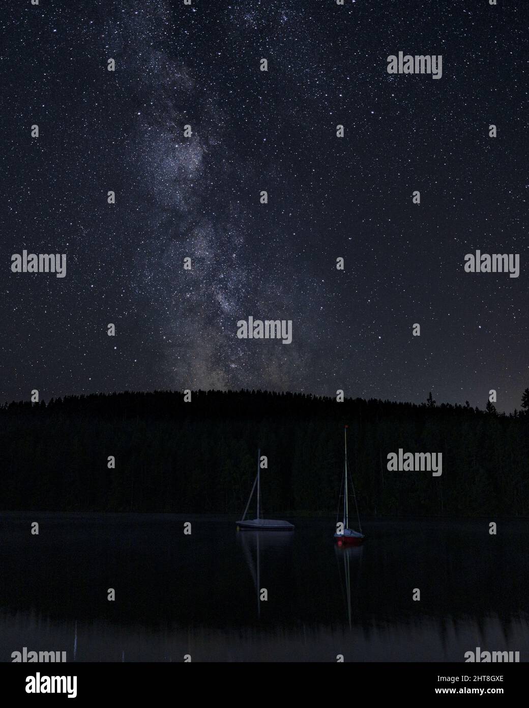 Vertical shot of the beautiful Milky Way in the night sky full of stars ...