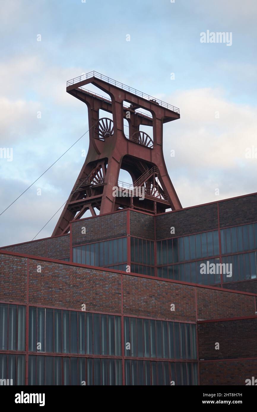Vertical shot of an old mine tower next to building Stock Photo - Alamy