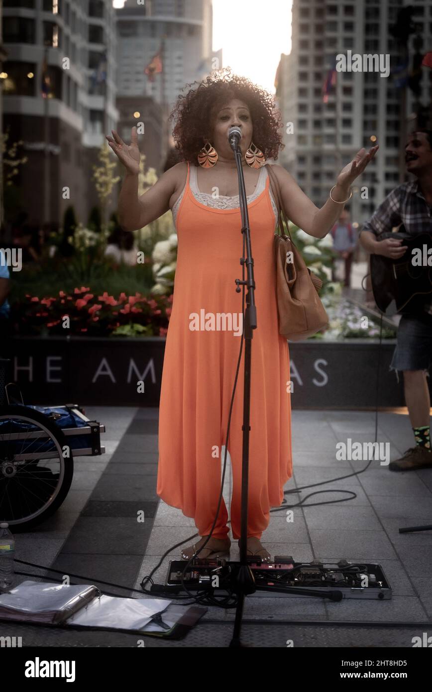 On stage singing orange dress hi-res stock photography and images - Alamy