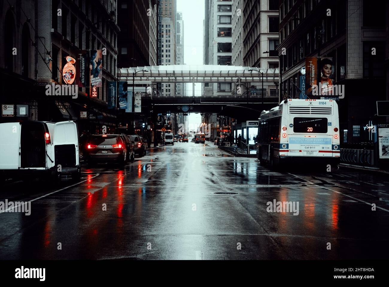 Street on a rainy day surrounded with tall buildings Stock Photo - Alamy