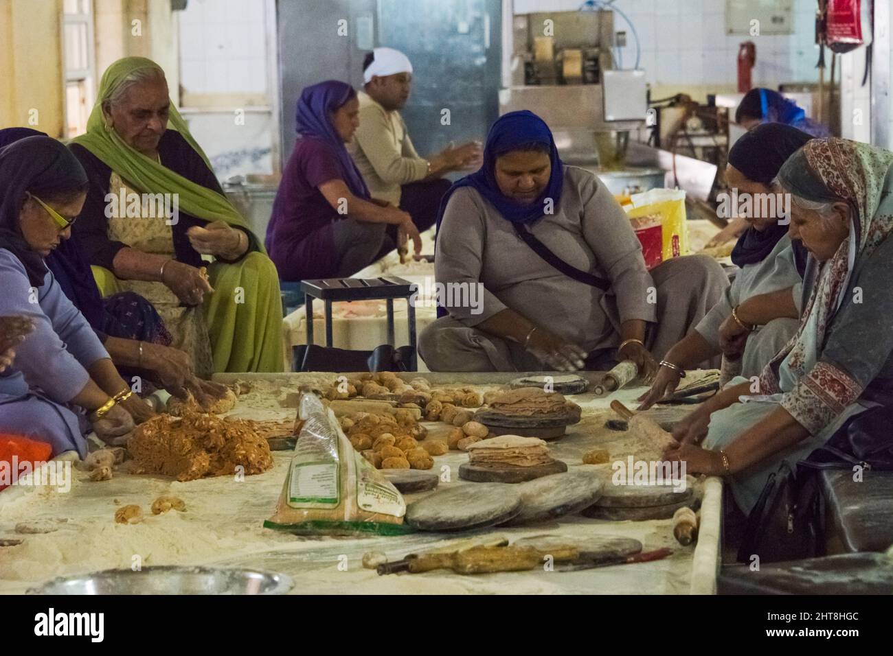 Preparing food to feed pilgrims in the kitchen of Gurudwara Bangla ...