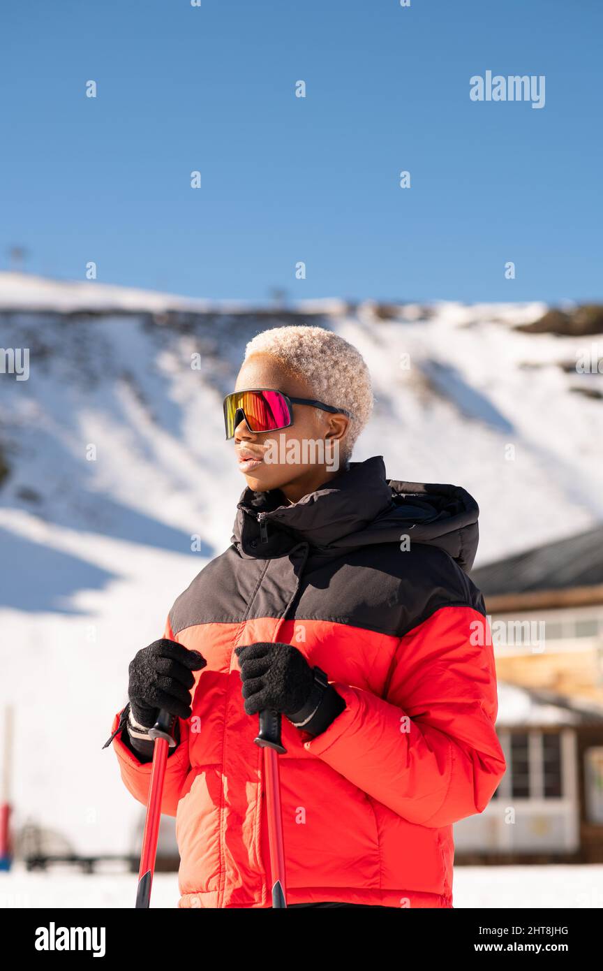 Vertical portrait of an African American female in a skiing uniform on ...