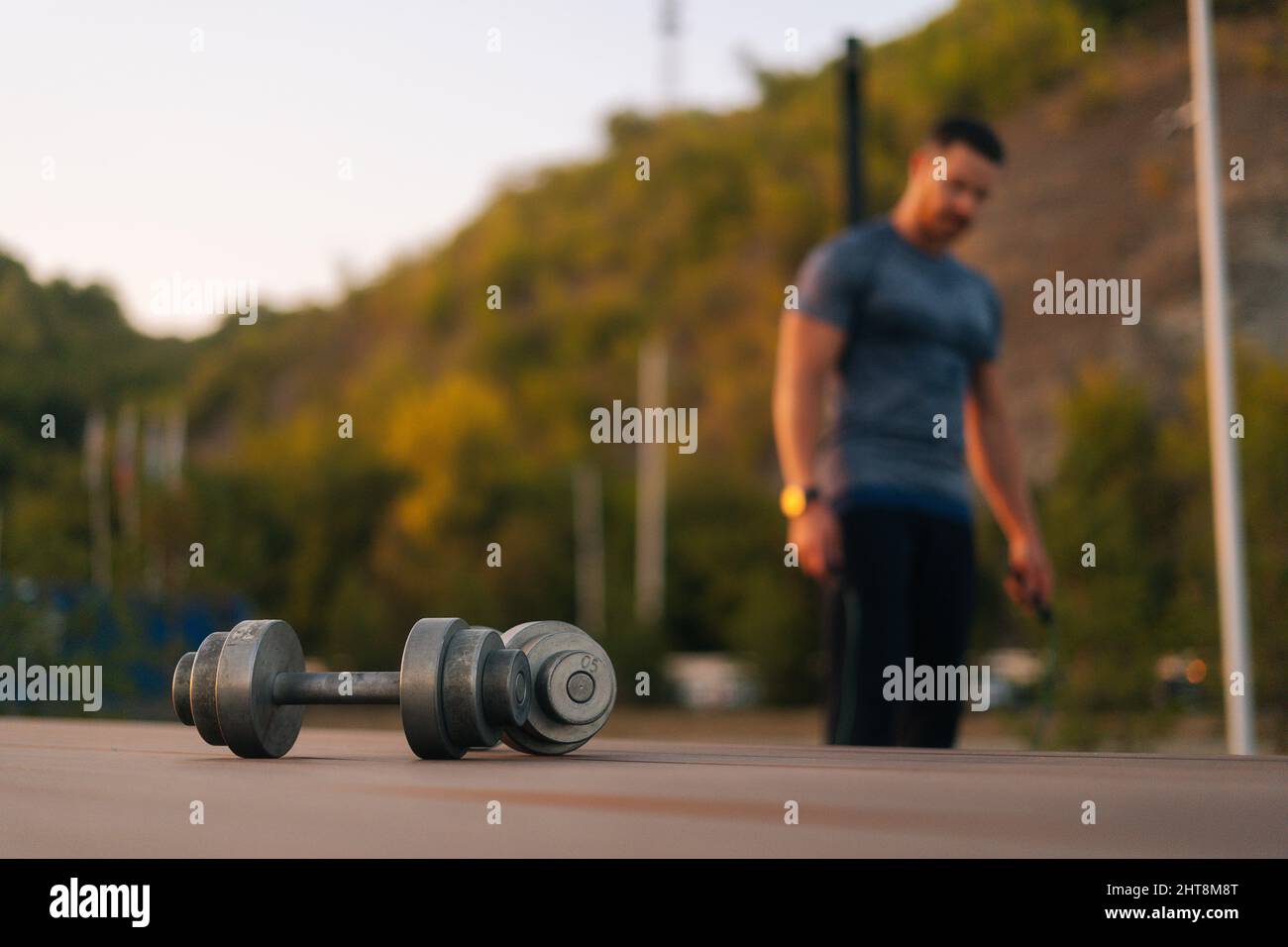 Blurred unrecognizable sportsman with strong muscular body looking at ...