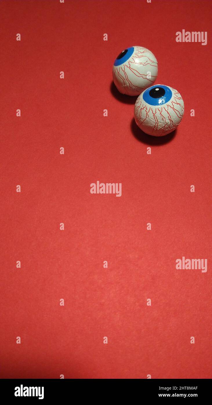 Candy chocolate eyes of Halloween isolated on a red background Stock ...