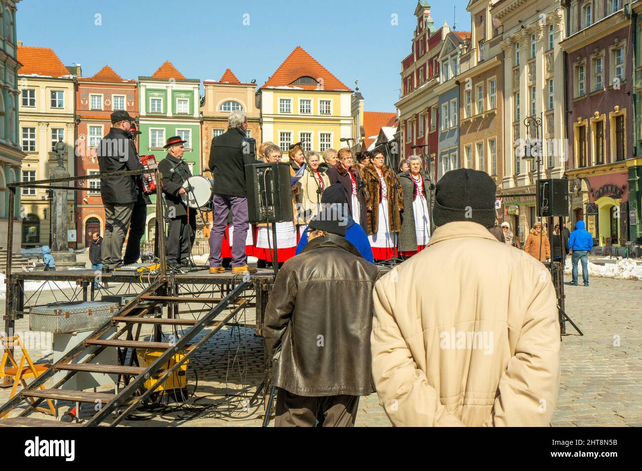 Group of women dressed in traditional clothes singing on a stage ...