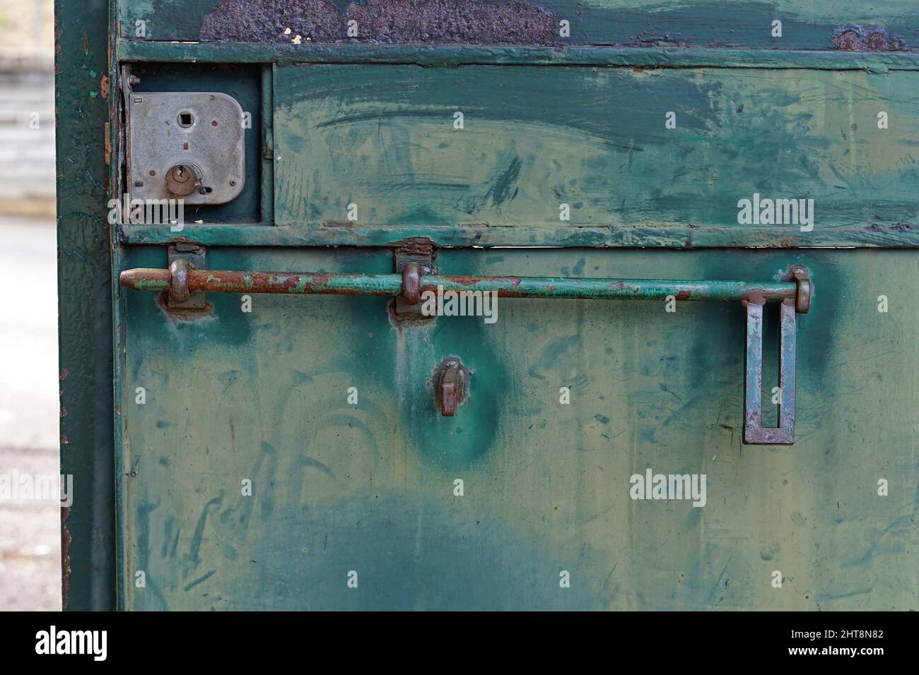 Lock latch safety device at old green gate Stock Photo - Alamy