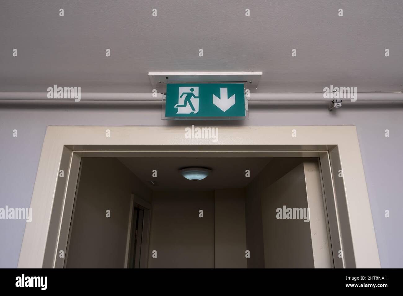 Emergency exit sign on the door Stock Photo - Alamy
