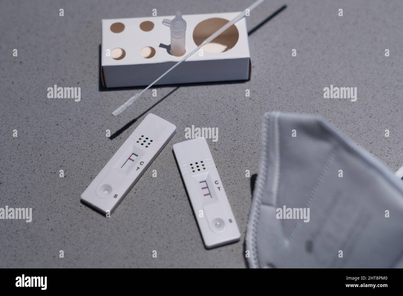 Positive and negative covid19 antigen test kits with face mask on a ...
