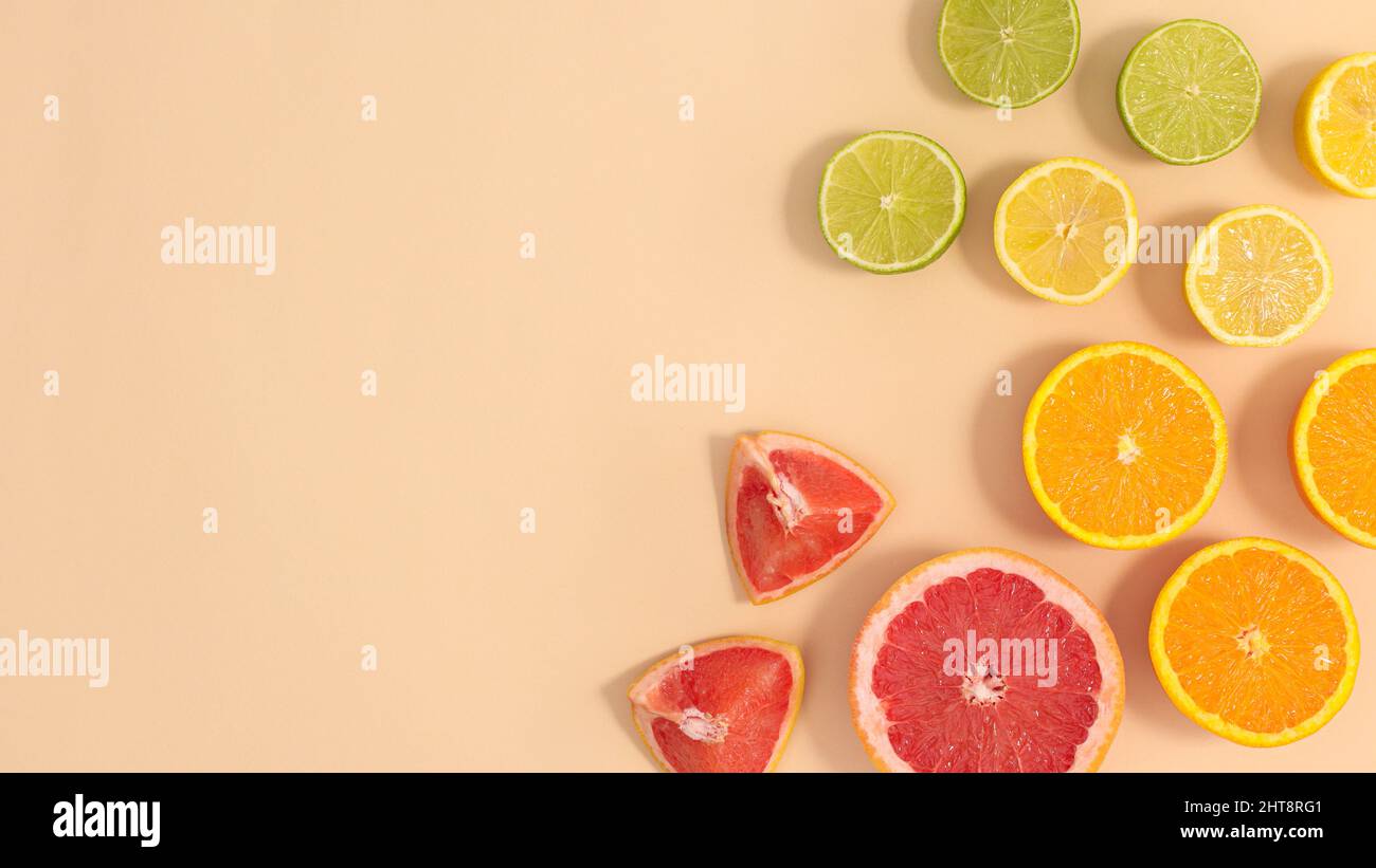 Creative citrus fruits arrangement on pastel beige background. Flat lay ...