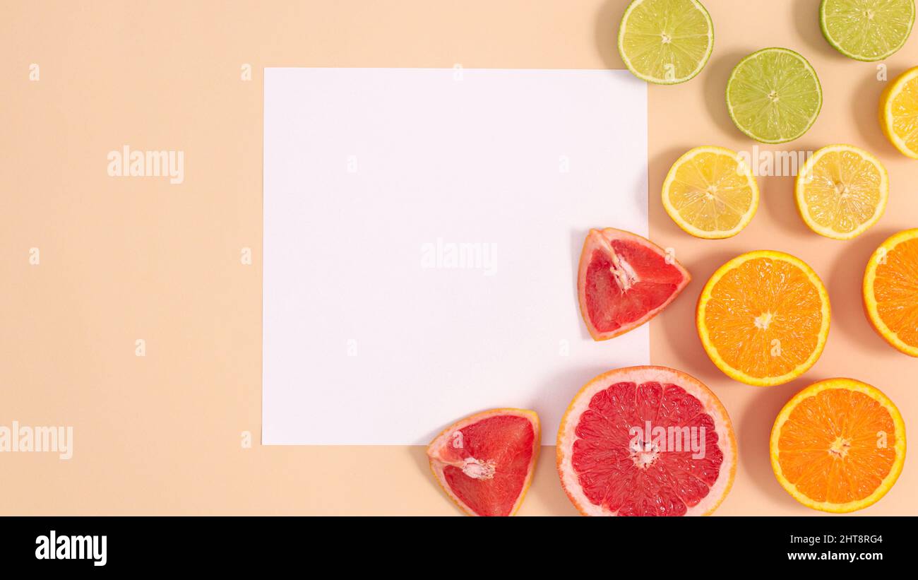 Creative paper card copy space with citrus fruits arrangement on pastel ...