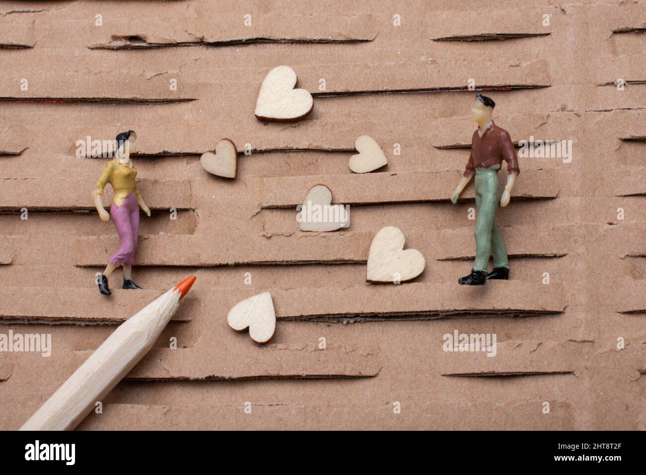 Tiny figurine of man and woman miniature model and heart as love ...