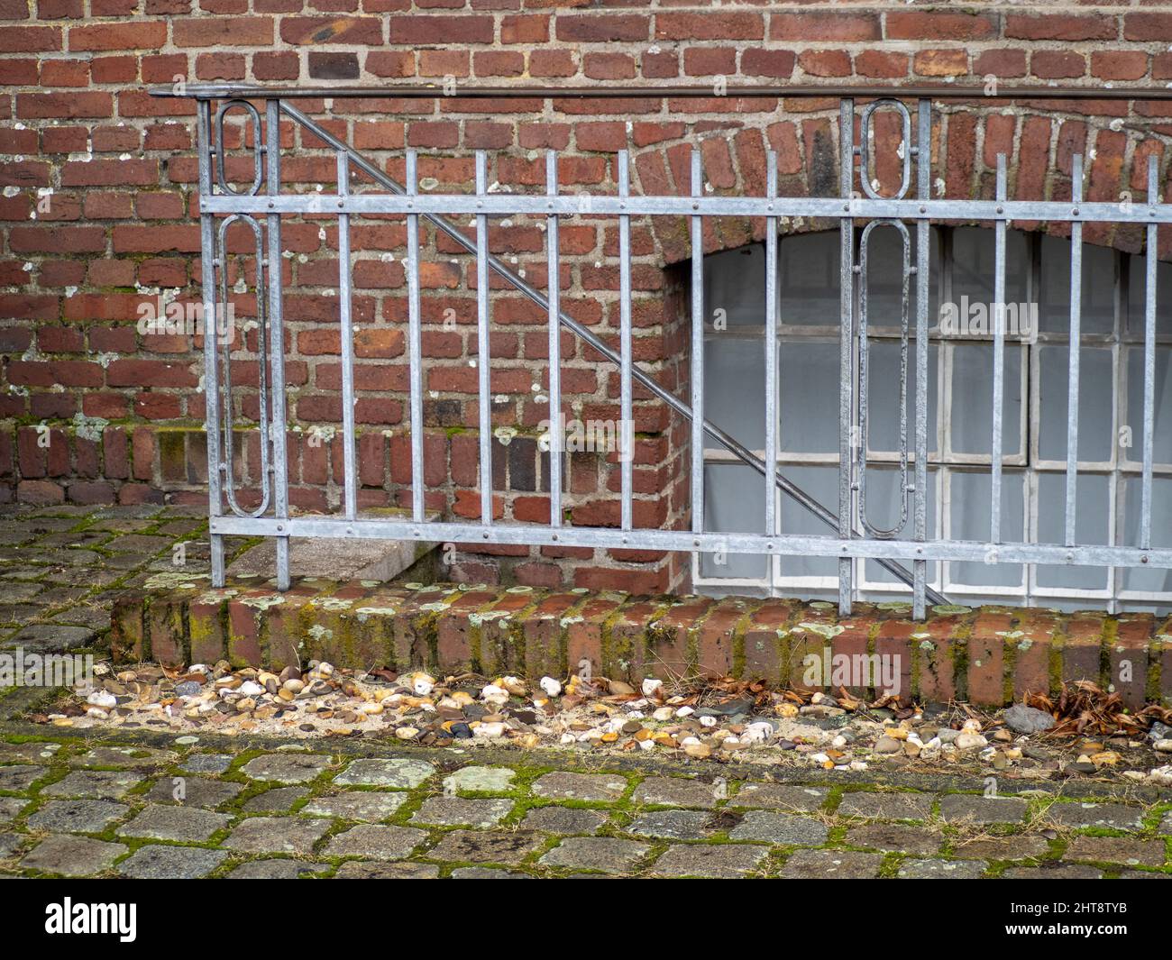 Fence in front of a window on a brick building Stock Photo - Alamy