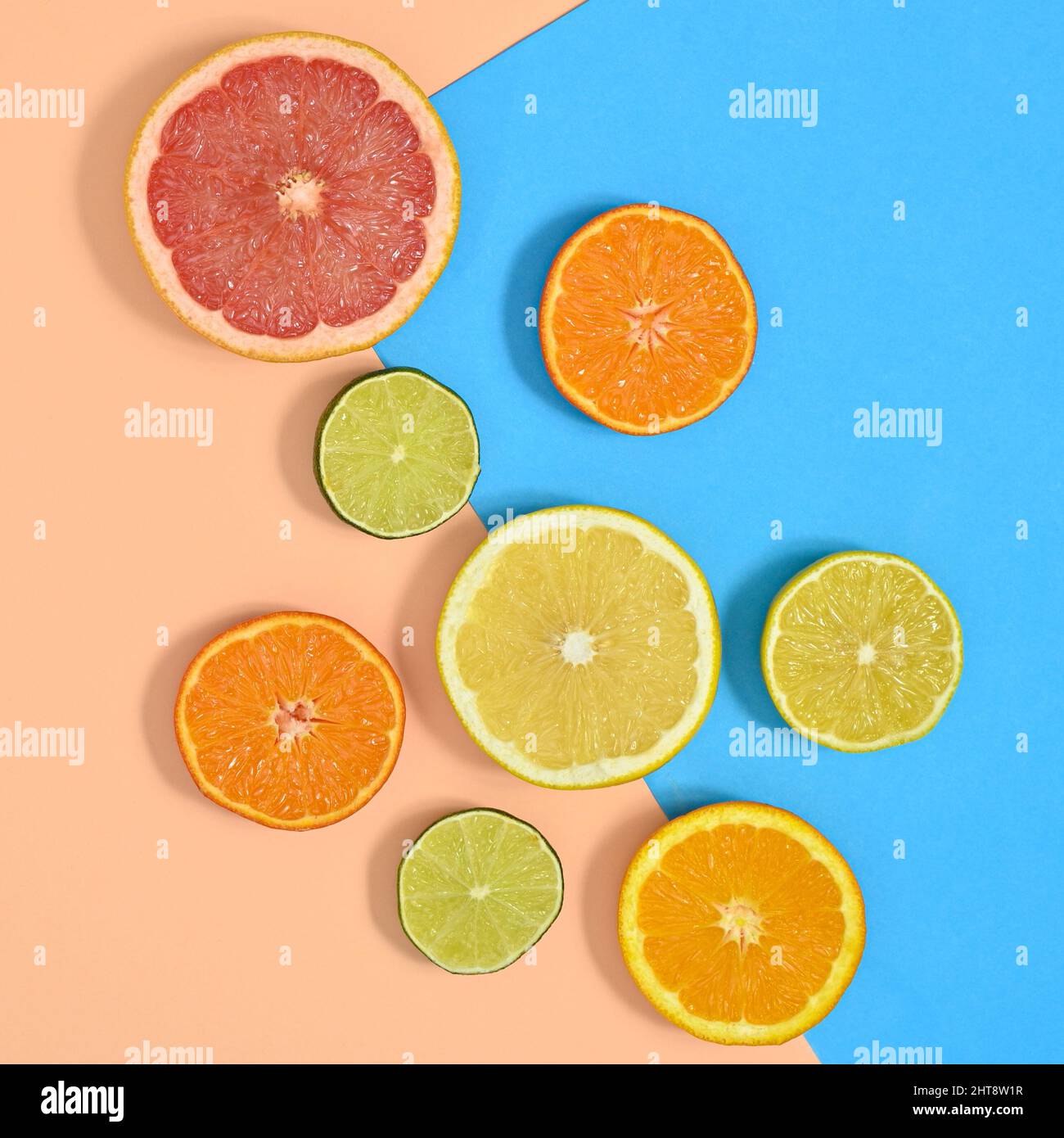 Summer citrus fruits composition on pastel beige and blue background ...