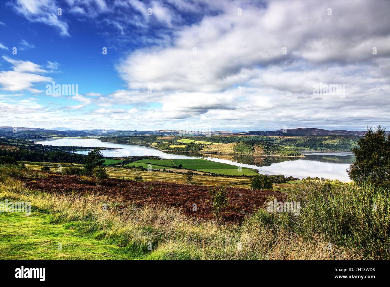 Green windy valley under the sky full of clouds and a river in the ...