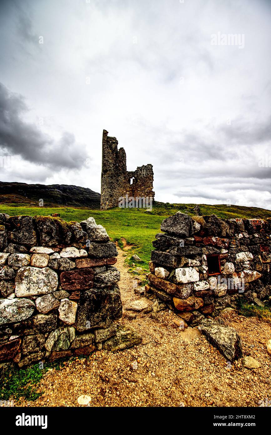 Vertical shot of stone castle ruins in wilderness under the gloomy sky ...