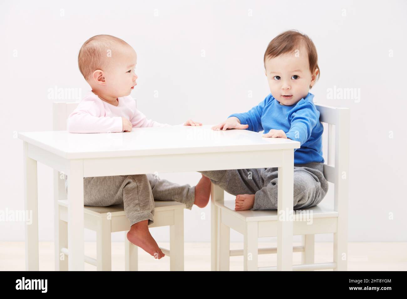 Boy girl sitting table hi-res stock photography and images - Alamy